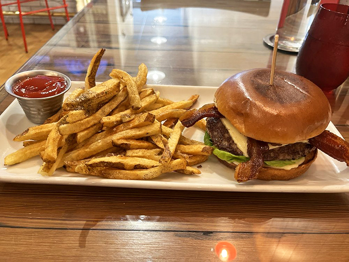 The burger that launched a thousand road trips—juicy, bacon-topped perfection with hand-cut fries that deserve their own fan club.