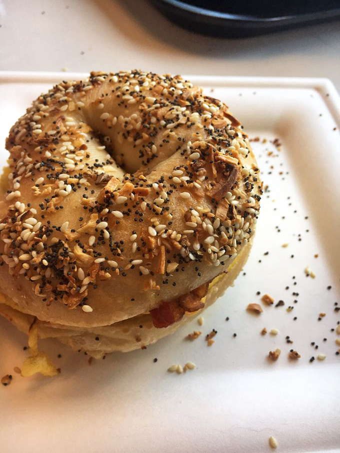 The everything bagel—where seeds gather for their annual convention and cheese peeks out like a shy but curious neighbor.