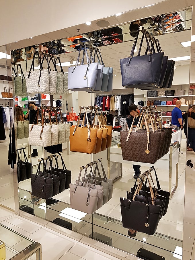 Designer handbags displayed like fine art in a gallery of leather and logos. The only difference? Here, you're encouraged to touch the exhibits.