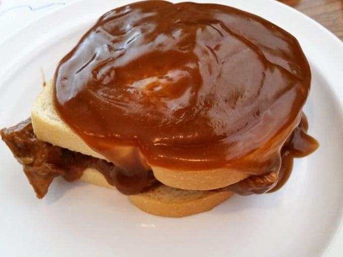 Gravy so rich it could buy a yacht, cascading over bread that's standing its ground with dignity. This sandwich doesn't need Instagram—it needs your full attention.