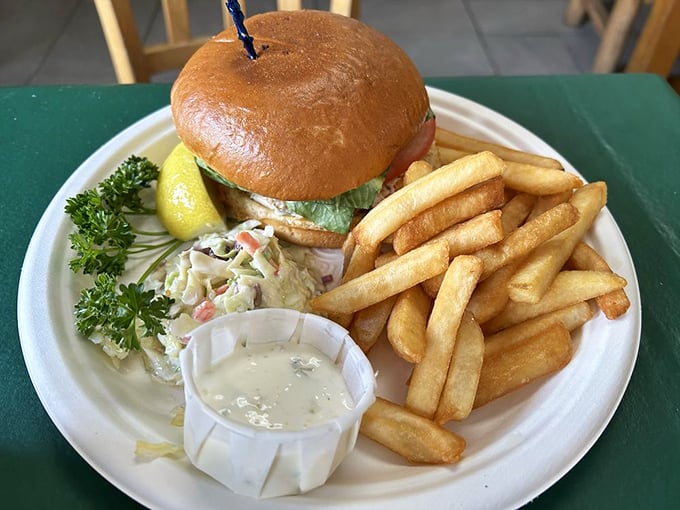 A seafood sandwich that doesn't hide behind fancy aiolis or trendy toppings—just honest-to-goodness fish on a bun with the requisite sides of happiness.