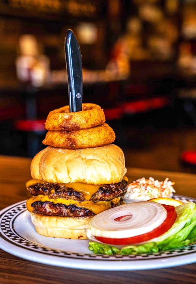 That knife isn't for cutting—it's holding down a burger that might otherwise float away on its own deliciousness.