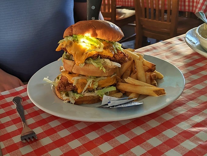 This isn't just a burger; it's a skyscraper of deliciousness that requires a game plan before the first bite. Structural engineering never tasted so good.
