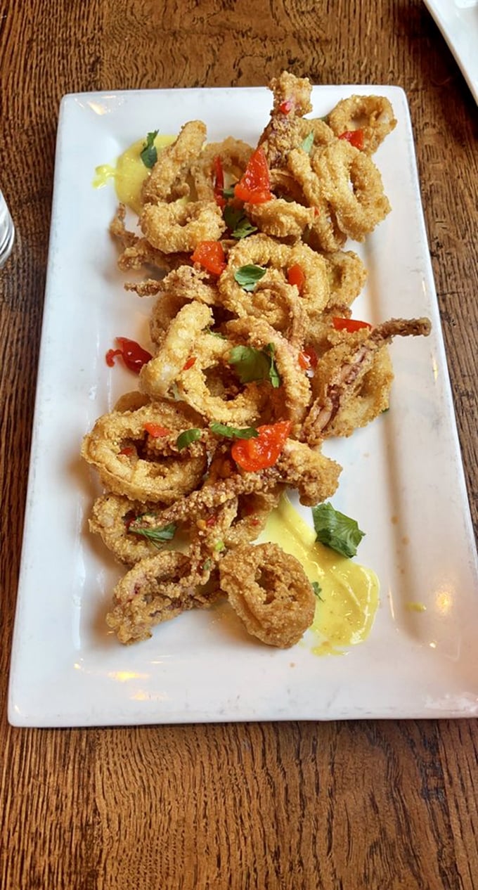 Calamari that defies the rubbery reputation of lesser versions – light, crisp, and brightened with sweet peppers and fresh herbs. No marinara monotony here.
