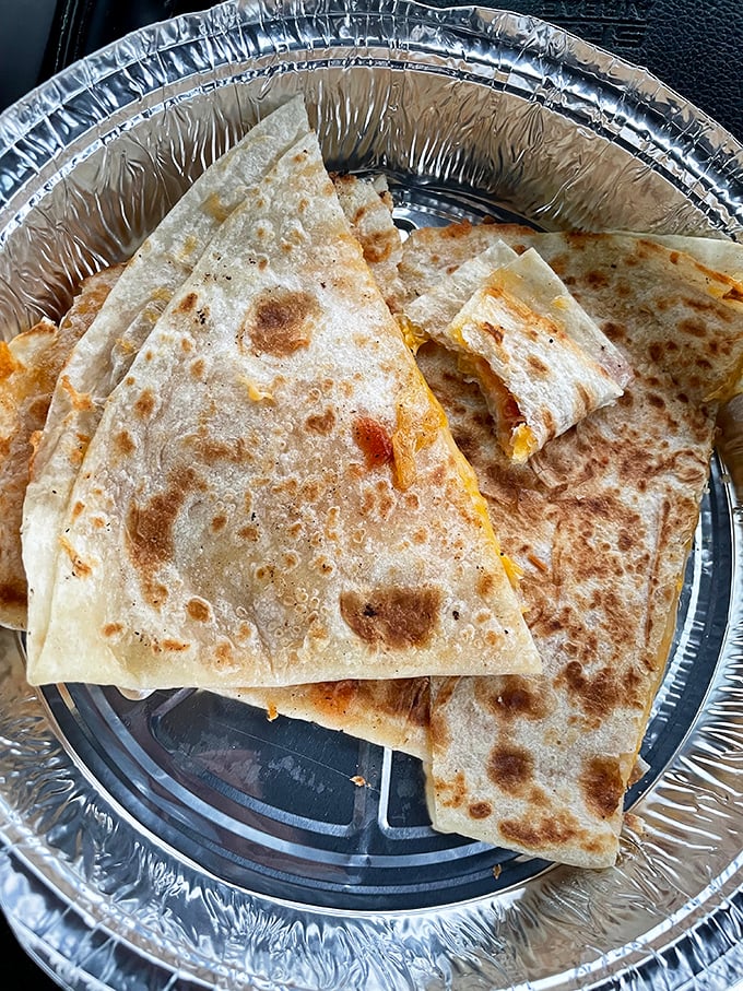Golden-brown, perfectly grilled quesadilla triangles. That crispy exterior hides a molten cheese interior that stretches for days.