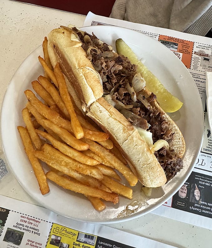The classic Philly cheesesteak and fries—a sandwich so perfect it makes you wonder why you'd ever eat anything else.