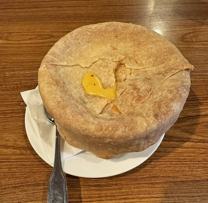 Beneath this golden-brown pastry fortress lies a savory treasure of chicken and vegetables—comfort food architecture at its finest.