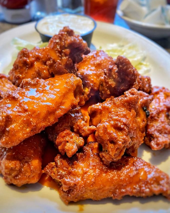 Buffalo wings with that perfect crisp-to-sauce ratio—the kind that make you wonder why anyone bothers with fancy food when this exists.