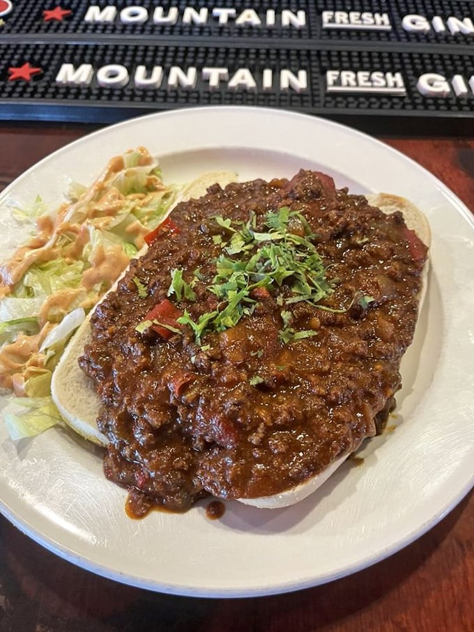 Chili so serious it demands an equally committed vessel. This open-faced sandwich doesn't just satisfy hunger—it conquers it completely.