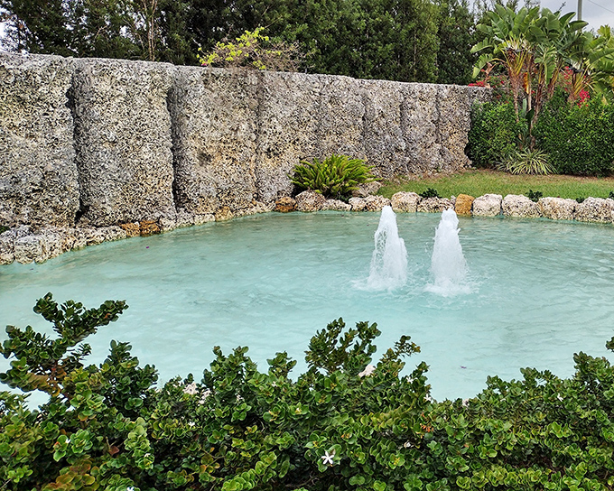 Tranquil turquoise waters and dancing fountains provide a serene contrast to the imposing coral walls. Nature meets human ingenuity in perfect harmony.