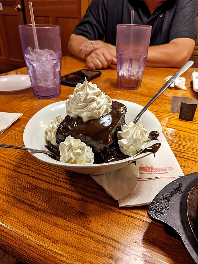 A chocolate dessert so decadent it should require a permission slip. Those whipped cream peaks aren't just garnish—they're essential diving boards into chocolate bliss.