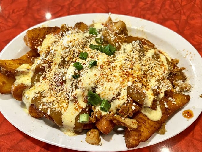 The Little Dirty: where jo-jos meet their destiny under a blanket of smoked chicken, Creole gravy, and enough cheese to make Wisconsin nervous.