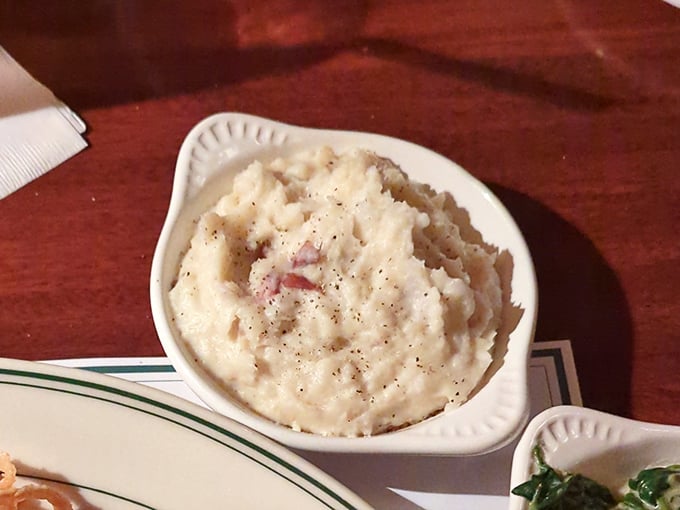 These mashed potatoes aren't whipped into some airy cloud-like nonsense—they're substantial, honest spuds with just enough lumps to prove they're real.