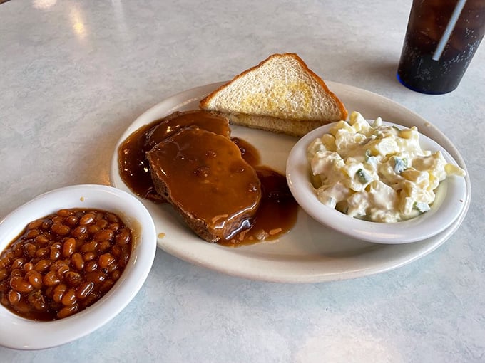 Meatloaf that doesn't need a fancy introduction—just beans that mean business, potato salad with personality, and gravy that demands to be sopped up with toast.