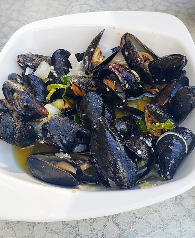 Mussels bathed in fragrant broth—like tiny treasure chests that open to reveal oceanic jewels.
