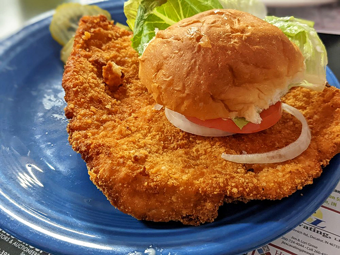 The legendary tenderloin in its natural habitat—a golden-brown disk of happiness that makes the bun look like it's playing hide and seek.