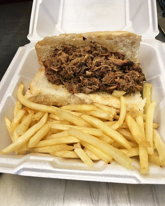 A proper pulled pork sandwich should require both hands and several napkins—this one passes the test with smoky, succulent glory.