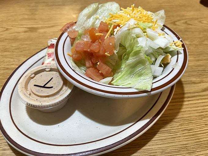 Even the side salad gets the respect it deserves—crisp lettuce, fresh tomatoes, and shredded cheese waiting for its moment in the spotlight.