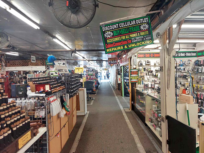 Cell phone repair meets vintage electronics in this tech alley—proof that at Fleamasters, there's a solution for every modern problem and retro obsession.