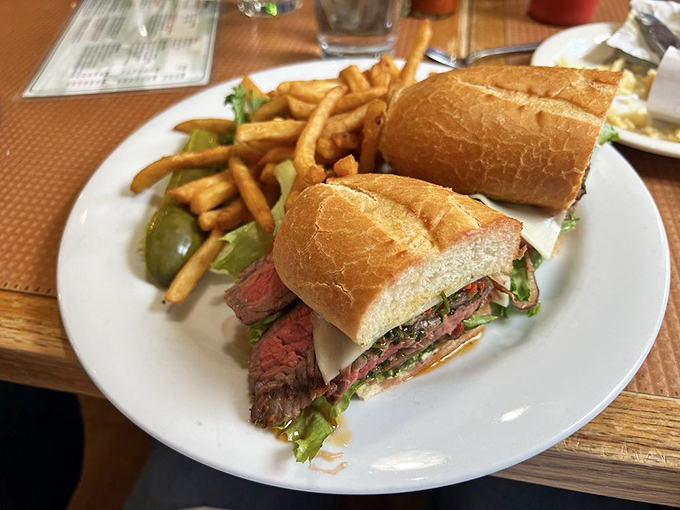 This isn't just a sandwich—it's architecture. Perfectly pink steak, crusty bread, and fresh greens creating the Taj Mahal of lunch options.