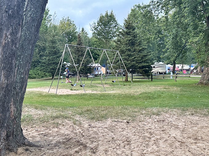 Swings with a view of campsites beyond—childhood joy meets adult camping comfort in perfect Upper Peninsula harmony.