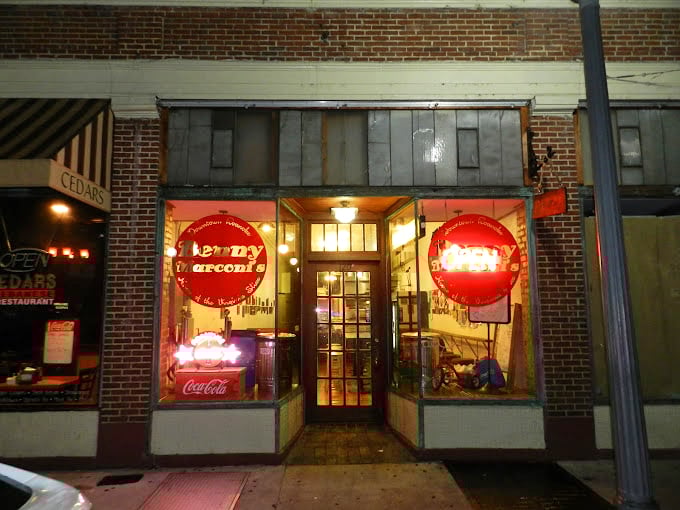 Benny Marconi's vintage storefront with its glowing red signs feels like stepping into a pizza time machine.