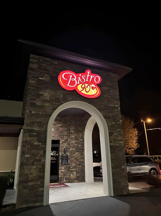 Bistro 90's dramatic stone archway entrance—like a portal to a world where calories don't count and steaks reign supreme.