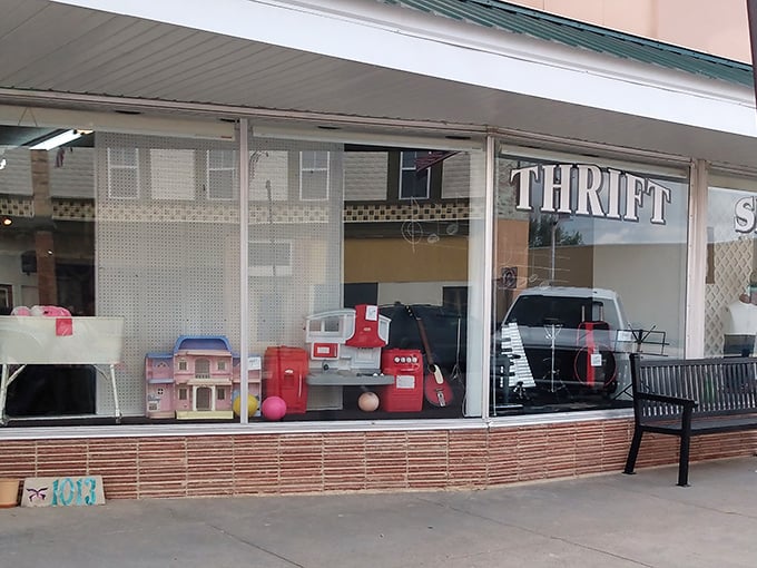 Small-town charm meets big bargain energy! Ellis Community Thrift Shop's window displays hint at the treasures within.