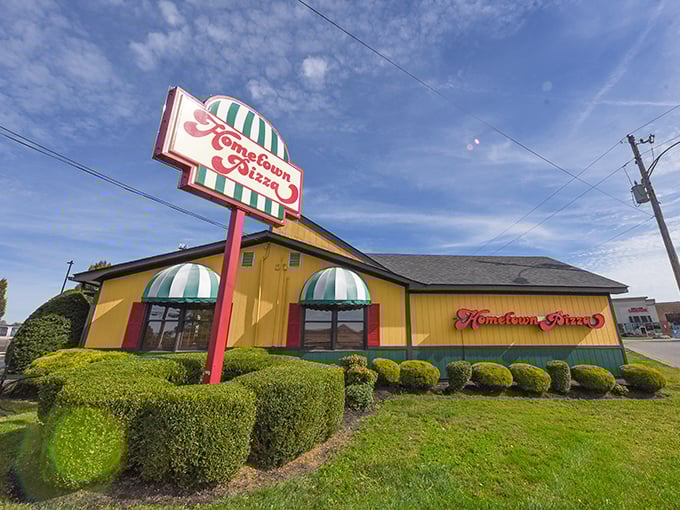 Bright yellow with striped awnings—like a pizza circus that delivers on all its delicious promises!