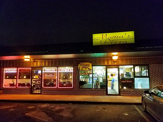 Mama's neon sign glows like a beacon in the night, guiding hungry pizza pilgrims to their cheesy destination.