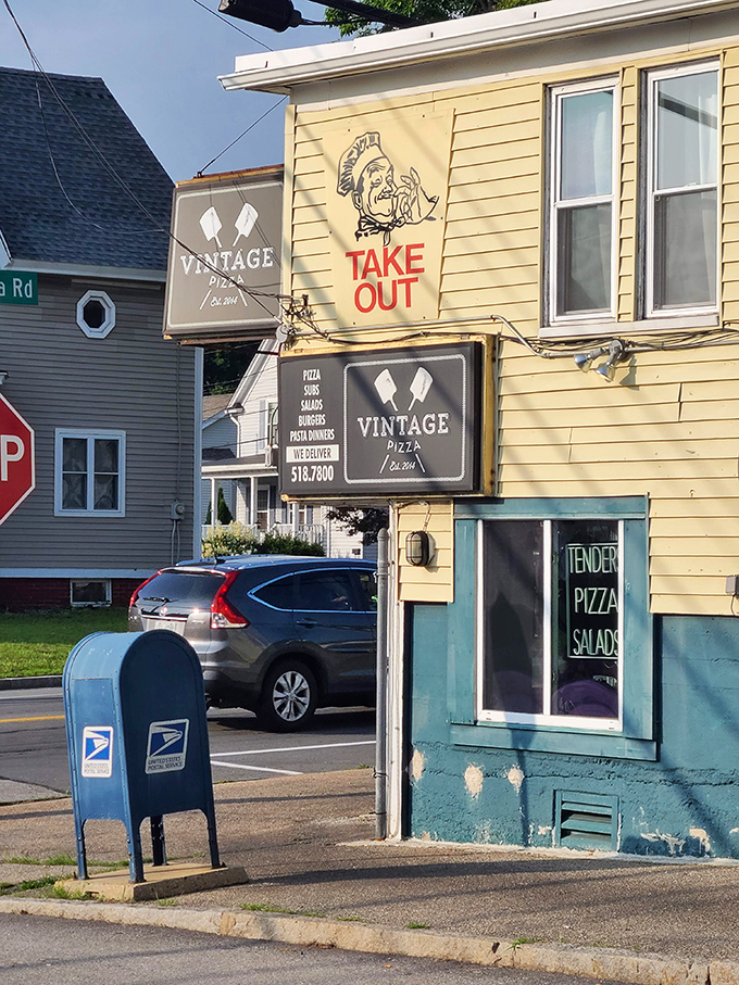 Vintage Pizza's yellow building and "TAKE OUT" sign are like a beacon for pizza lovers who know greatness comes in humble packages.