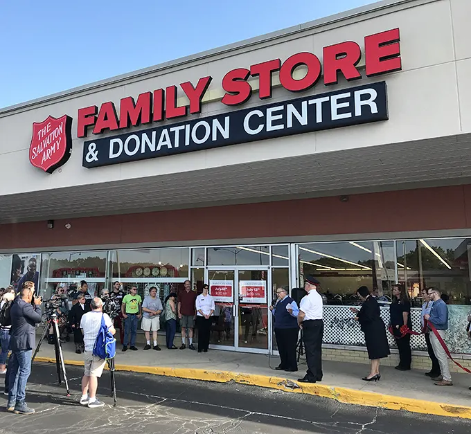 A gathering outside the Salvation Army store—perhaps a grand opening or special event where thrift meets community spirit.