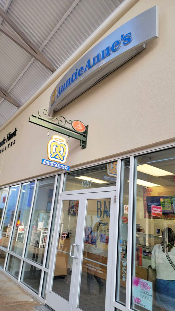 The unmistakable aroma of Auntie Anne's pretzels wafts through the walkway – the unofficial perfume of American malls since 1988.