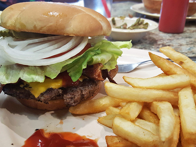 A proper diner burger doesn't need truffle aioli or artisanal buns—just quality beef, melty cheese, fresh toppings, and fries that snap when you bite them.