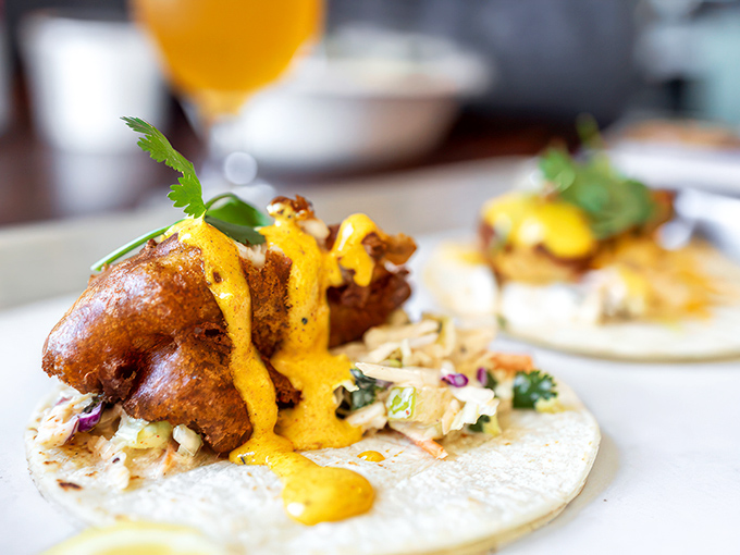 Who knew fish tacos could hold their own at a barbecue joint? That golden sauce is practically begging to be dripped down your arm.