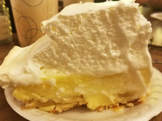 A slice of banana cream pie that would make your grandmother both proud and jealous – cloud-like meringue floating above golden custard.