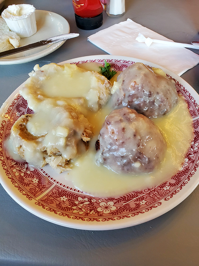 Biscuits swimming in gravy alongside meatballs that could make an Italian grandmother nod in respectful approval. Pure comfort on a plate.