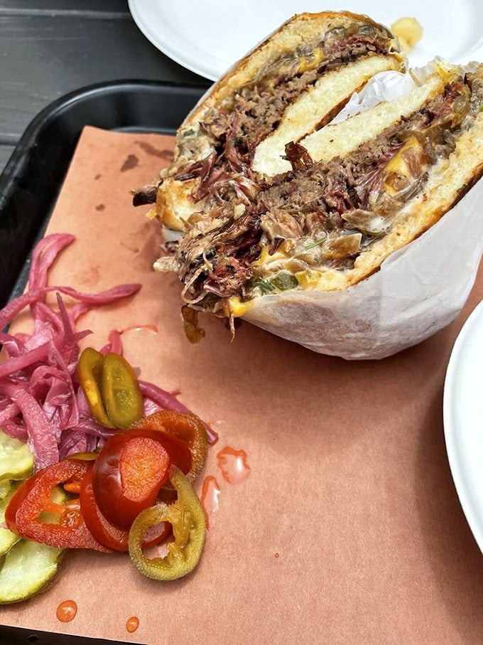 The sandwich that launches a thousand road trips—tender brisket embraced by pillowy bread with just enough pickled vegetables for balance.