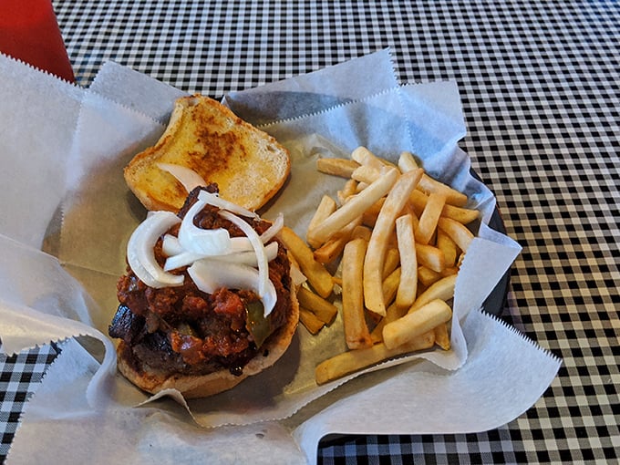 The classic American trinity—burger, fries, and Texas toast—presented on checkered paper with zero pretension and maximum satisfaction.
