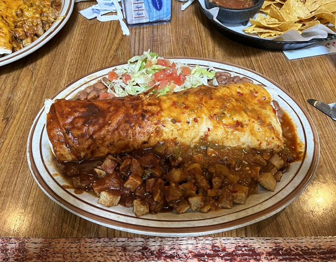 This burrito isn't just smothered in red chile sauce—it's having a full-on spa treatment in it. Pure New Mexican bliss.