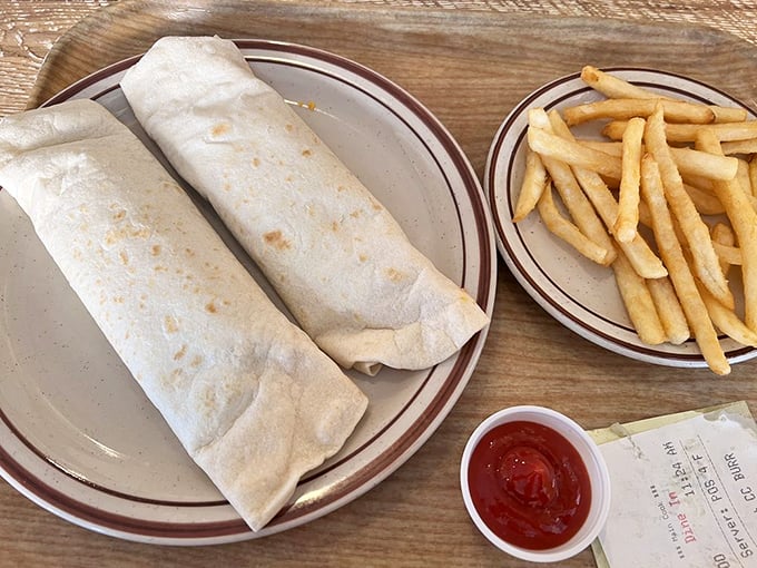 These burritos aren't just wrapped, they're swaddled—like precious food babies bundled in flour tortilla blankets next to golden fries.