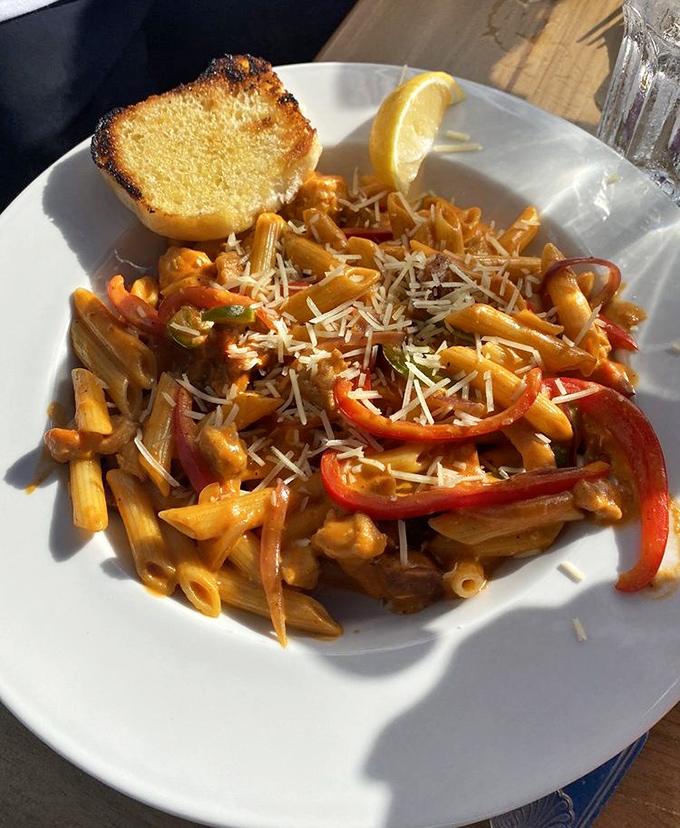 Pasta that doesn't just sit on the plate—it tells a story. Those red peppers and perfectly cooked penne are having the party your taste buds want to attend.