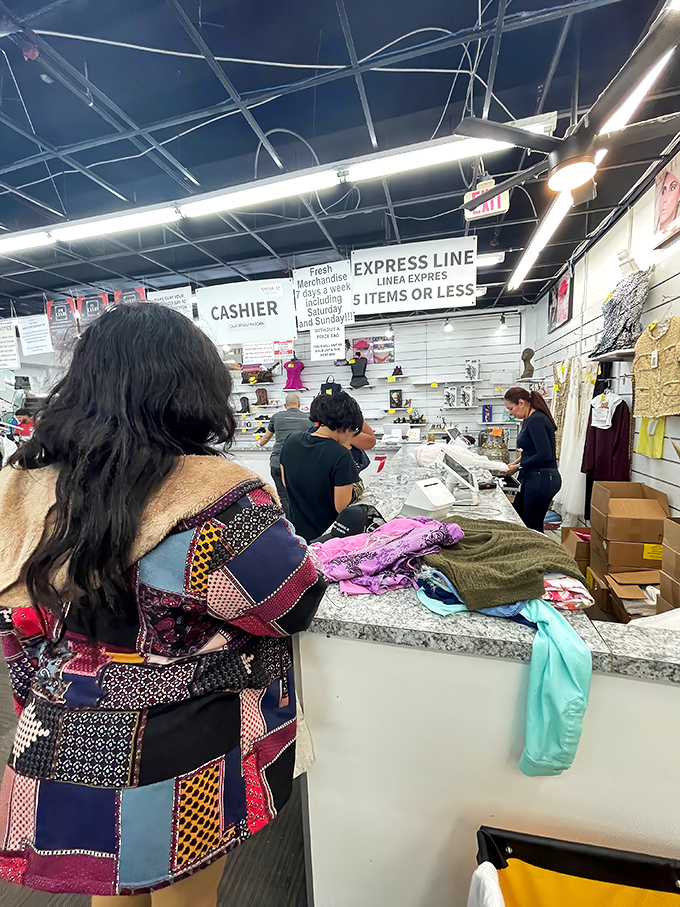The checkout line—where triumphant shoppers clutch their treasures like contestants who've just won the final round of a game show.