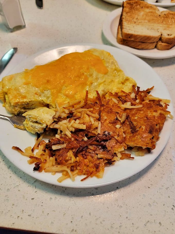 The golden marriage of fluffy omelet and crispy hash browns—a breakfast power couple that's been making mornings bearable since time immemorial.
