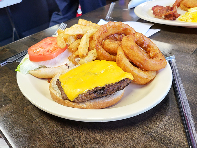 This isn't just a cheeseburger—it's a masterclass in diner perfection. Golden onion rings and crispy fries complete the holy trinity of lunch satisfaction.
