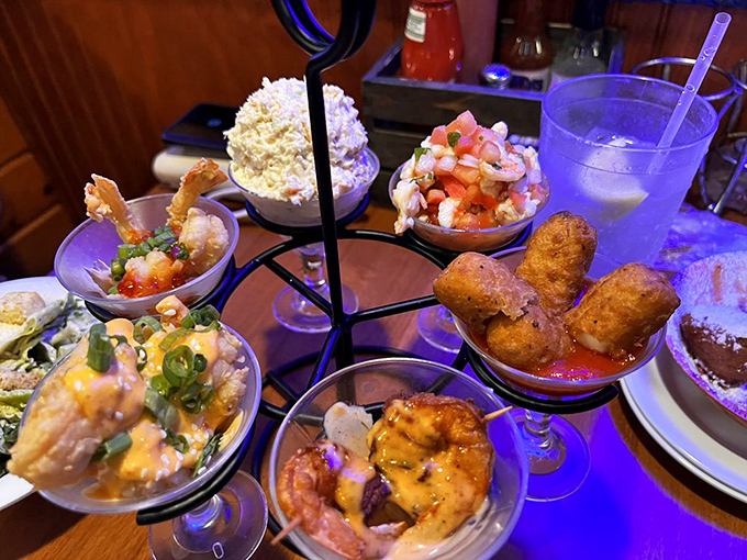 This isn't just an appetizer tower—it's a vertical seafood playground where each tiny bowl offers a different delicious adventure.