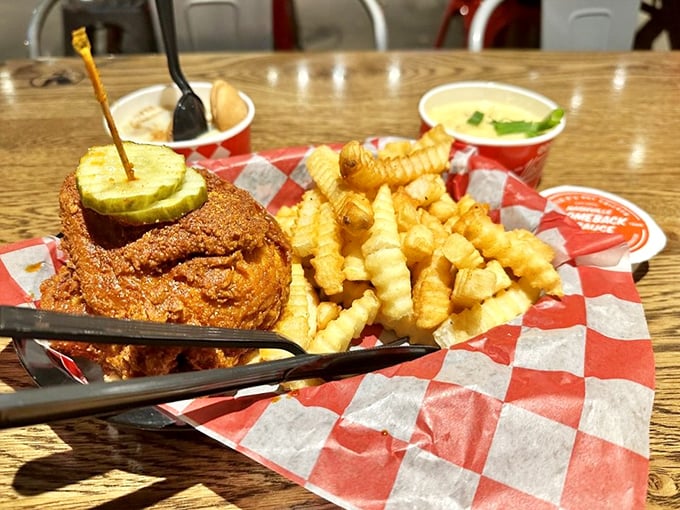 The pickle's not just decoration—it's nature's fire extinguisher, standing by while those perfect crinkle-cut fries provide moral support.