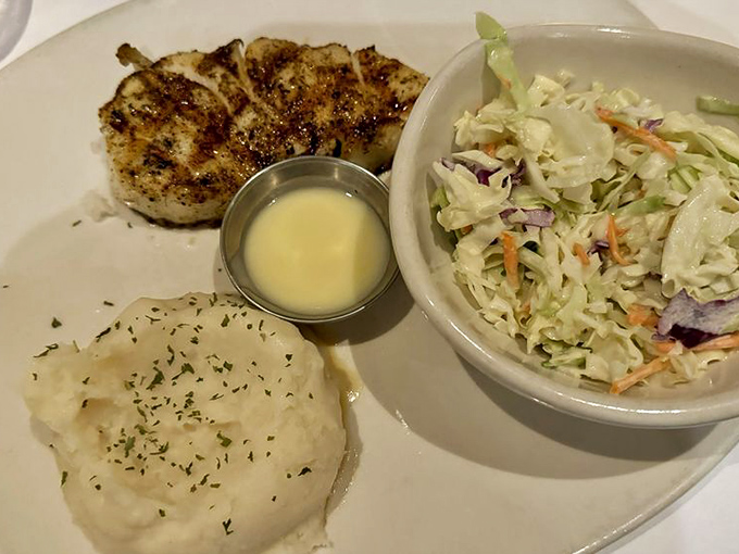 Perfectly grilled Chilean Sea Bass with vibrant green beans and whipped potatoes – simplicity that speaks volumes about quality ingredients.