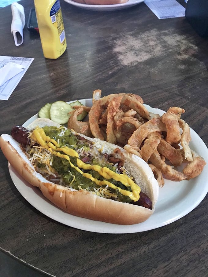 Hot dog enthusiasts, rejoice! This chili-smothered masterpiece with golden onion rings is what comfort food dreams are made of.