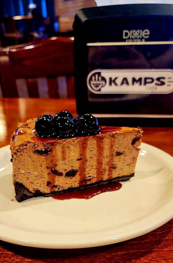 Dark chocolate drizzle meets plump cherries atop a canvas of creamy perfection. Some art belongs in museums; this belongs in your mouth.